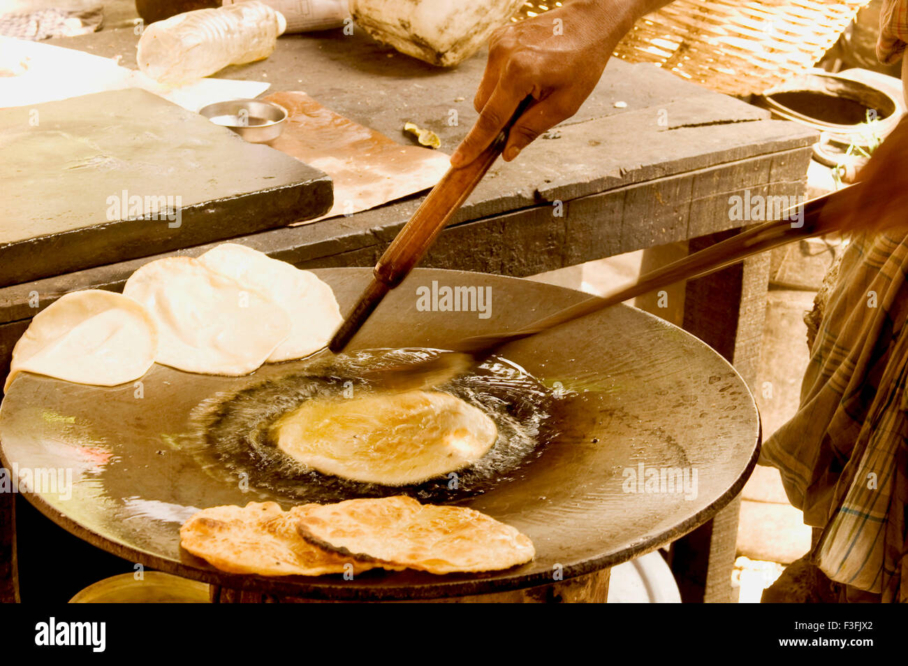 Paratha frying ; fried paratha ; flatbread cooking ; India ; Asia Stock ...