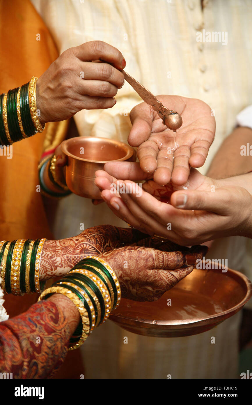 Kanyadan ; daughter hand giving to her husband performing ritual vidhi ...