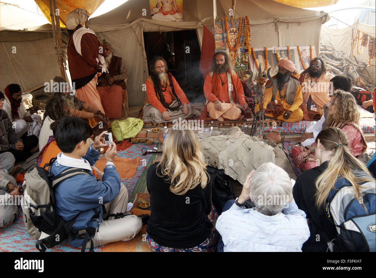 Sadhus from the Juna Akadha sit disciples most of them foreigners camp ...