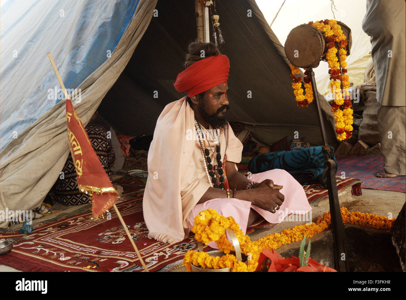 A naga sadhu from the Juna Akadha at his camp during the Ardh Kumbh ...