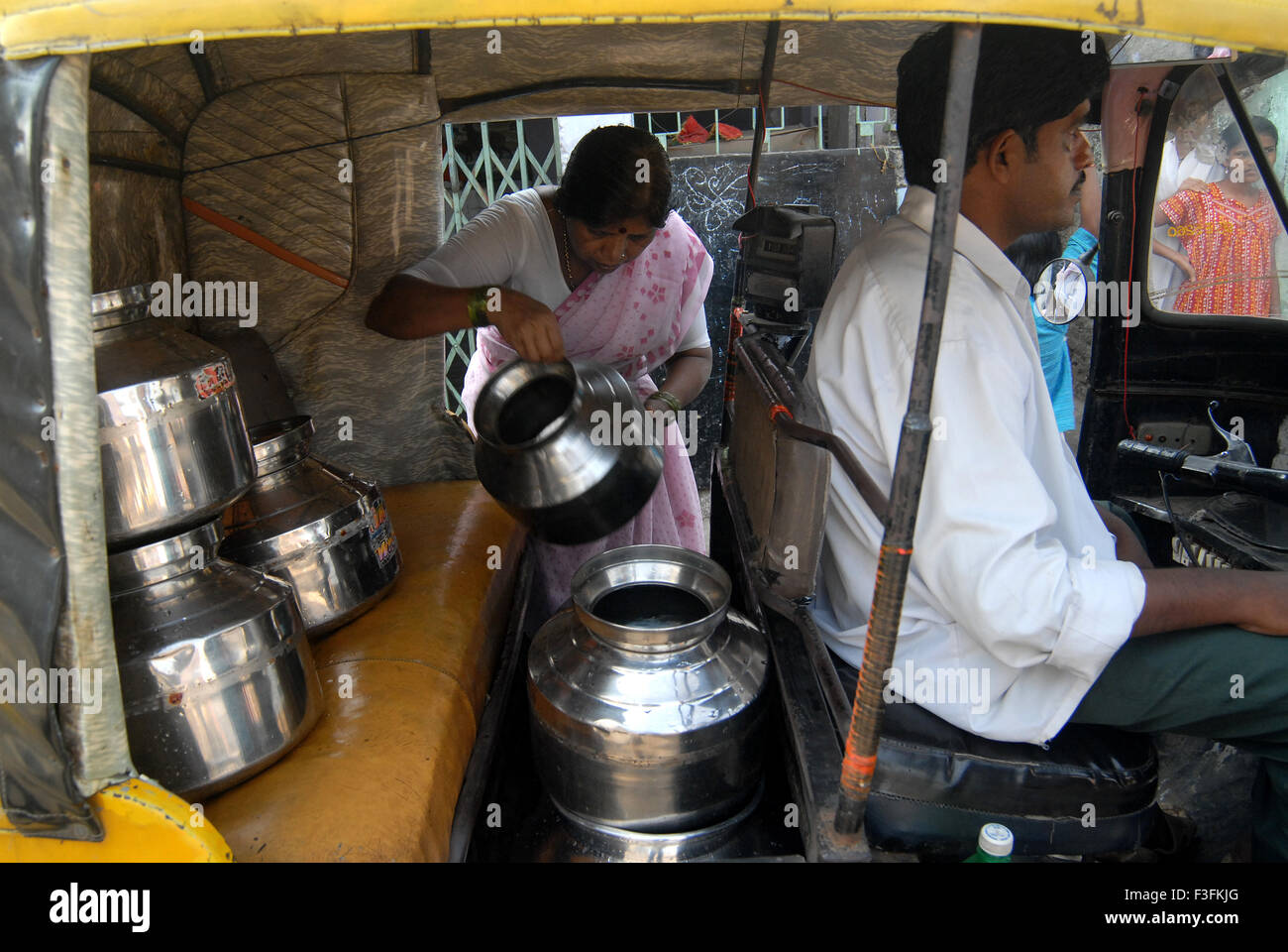 Woman fill containers water hi-res stock photography and images - Alamy