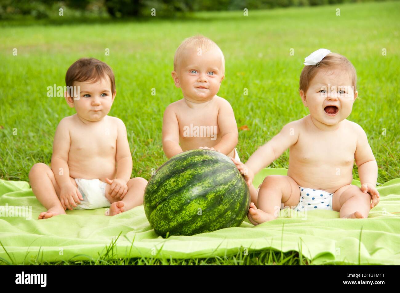 Babies with watermelon outdoors Stock Photo - Alamy
