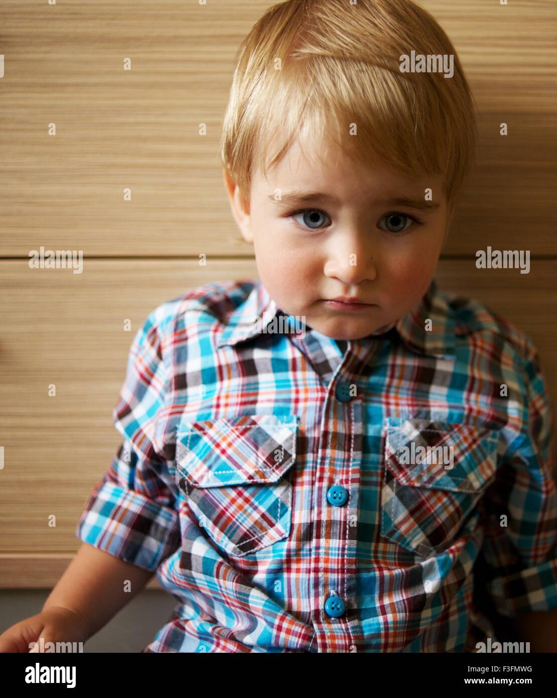 Sad little kid in a checkered shirt Stock Photo - Alamy