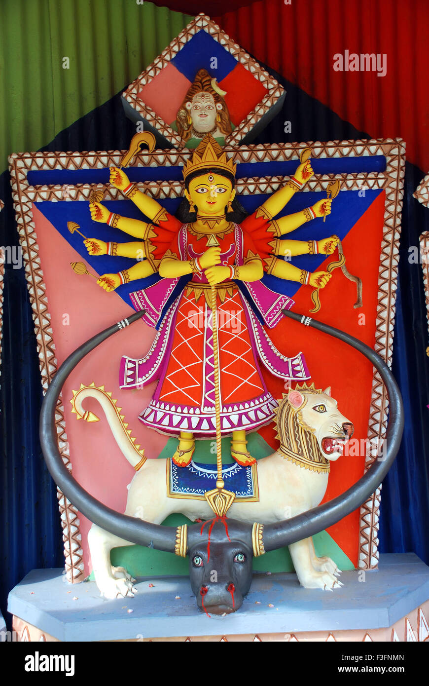 Decorative Durga clay model standing on lion killing demon mahishasura ...