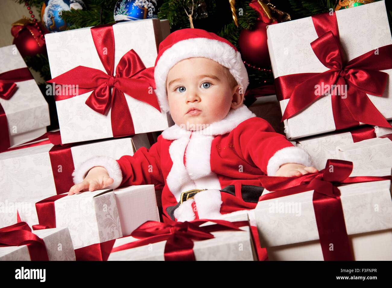 Little boy with gift boxes Stock Photo - Alamy