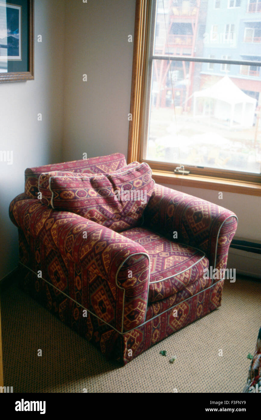 Single sofa on window side Stock Photo - Alamy