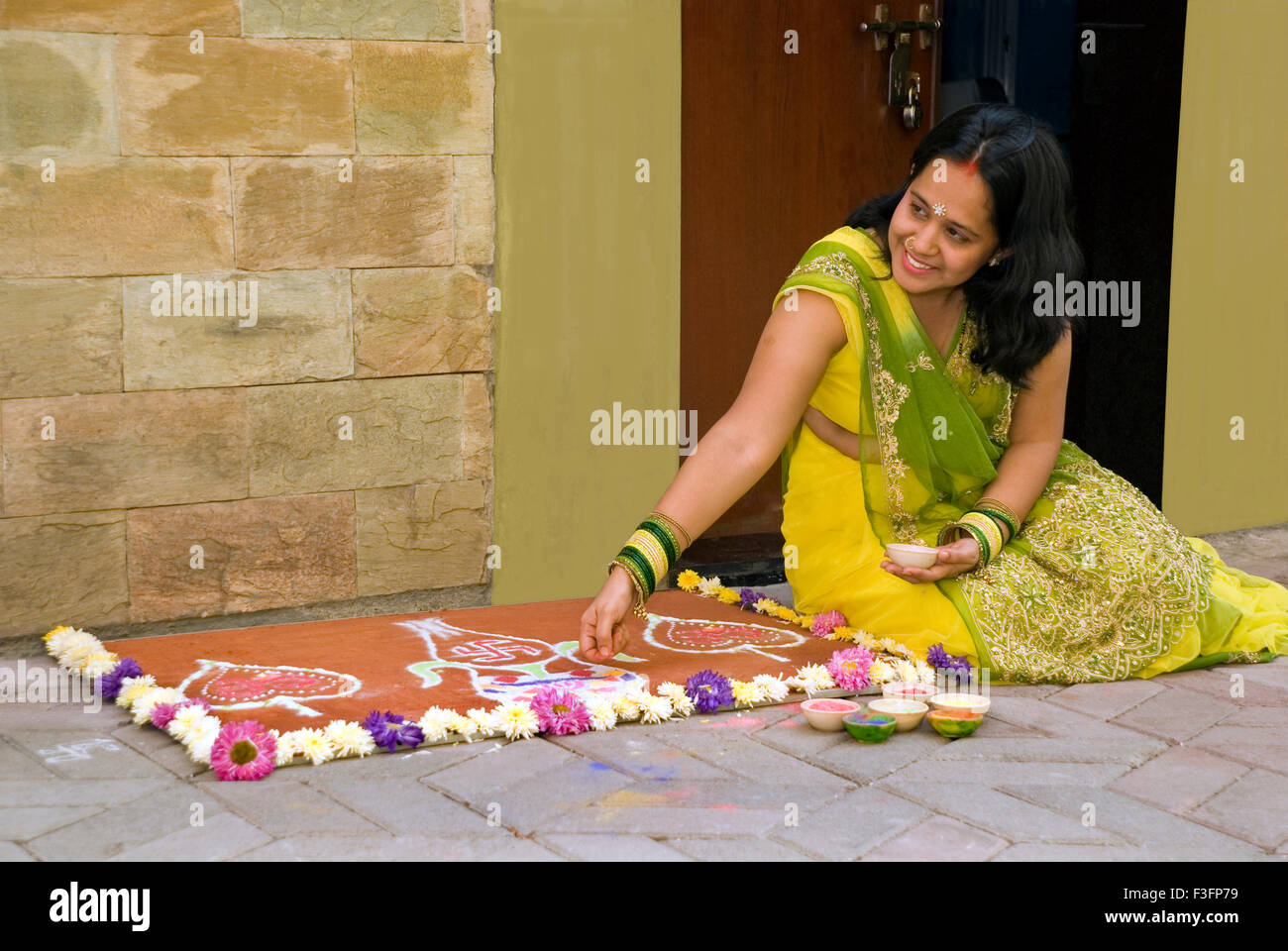 Lady drawing rangoli on the occasion of Diwali festival ; India MR#447D ...