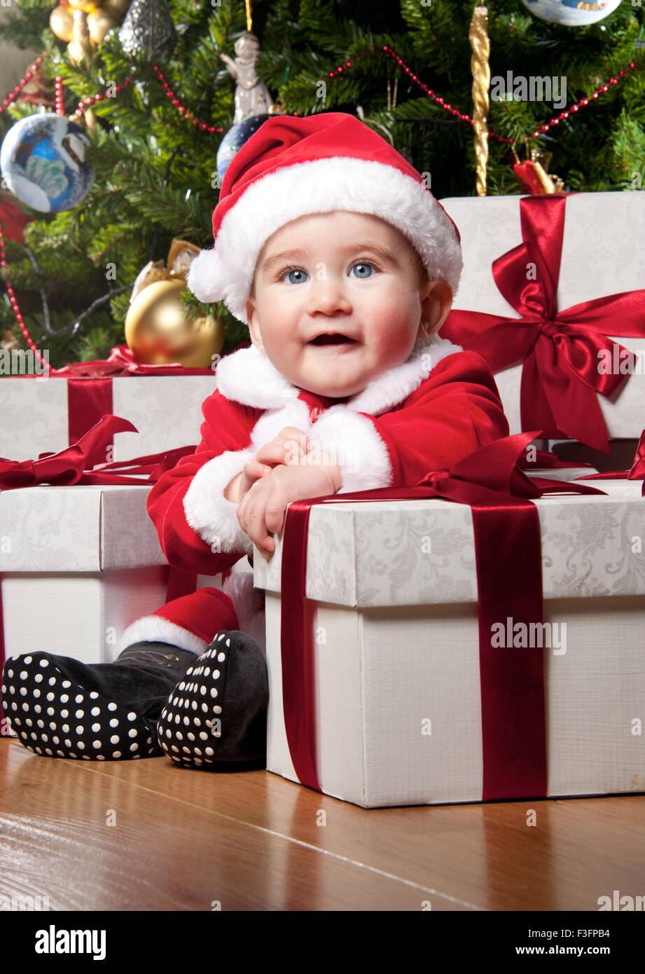 Little Santa boy with gift boxes Stock Photo - Alamy