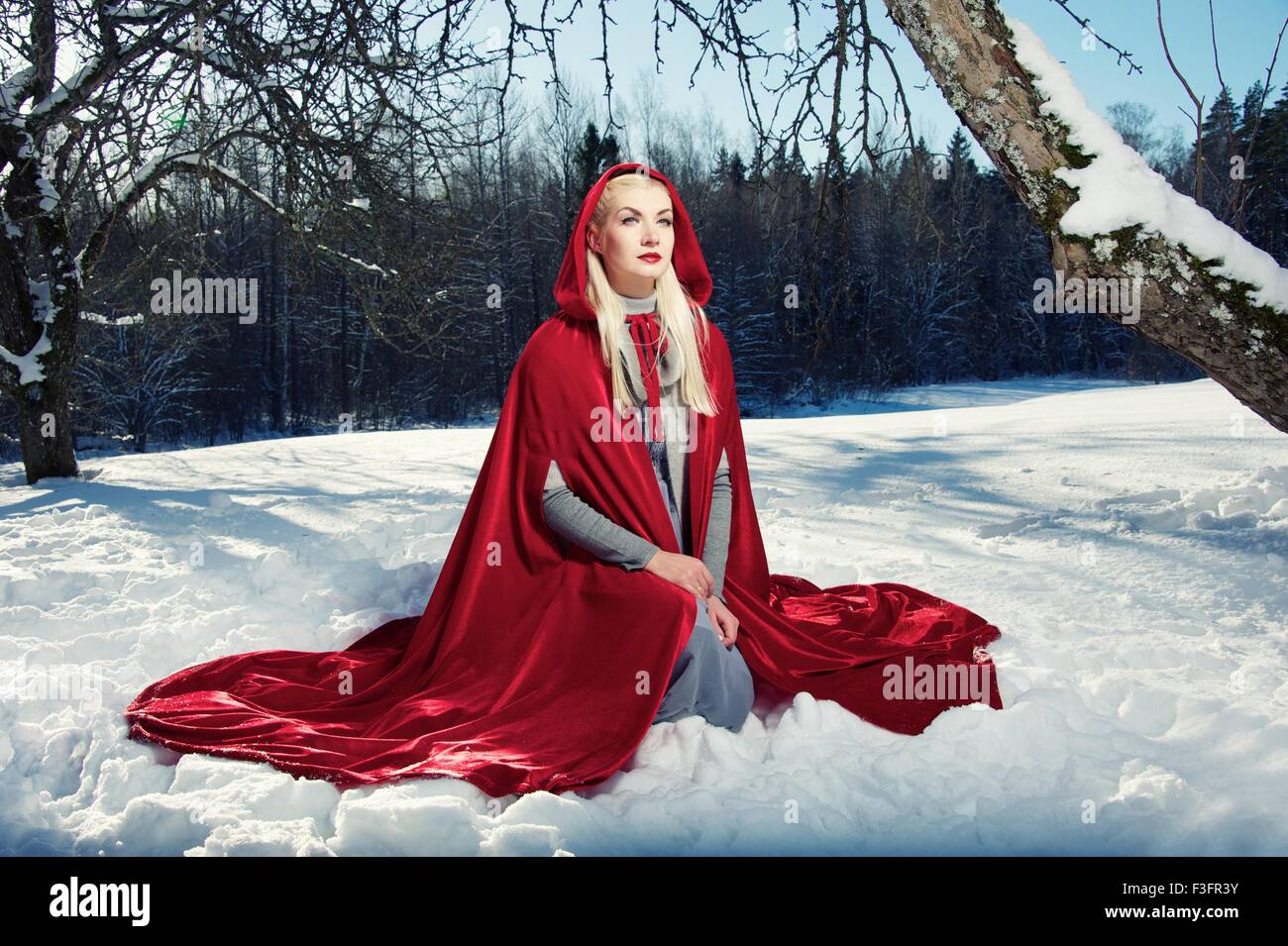 Red Hood sitting on a snow Stock Photo - Alamy