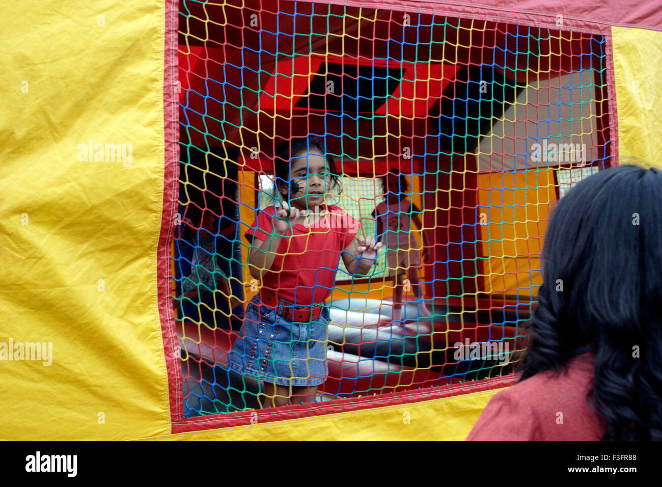 Girl looking at mother through net MR Stock Photo - Alamy
