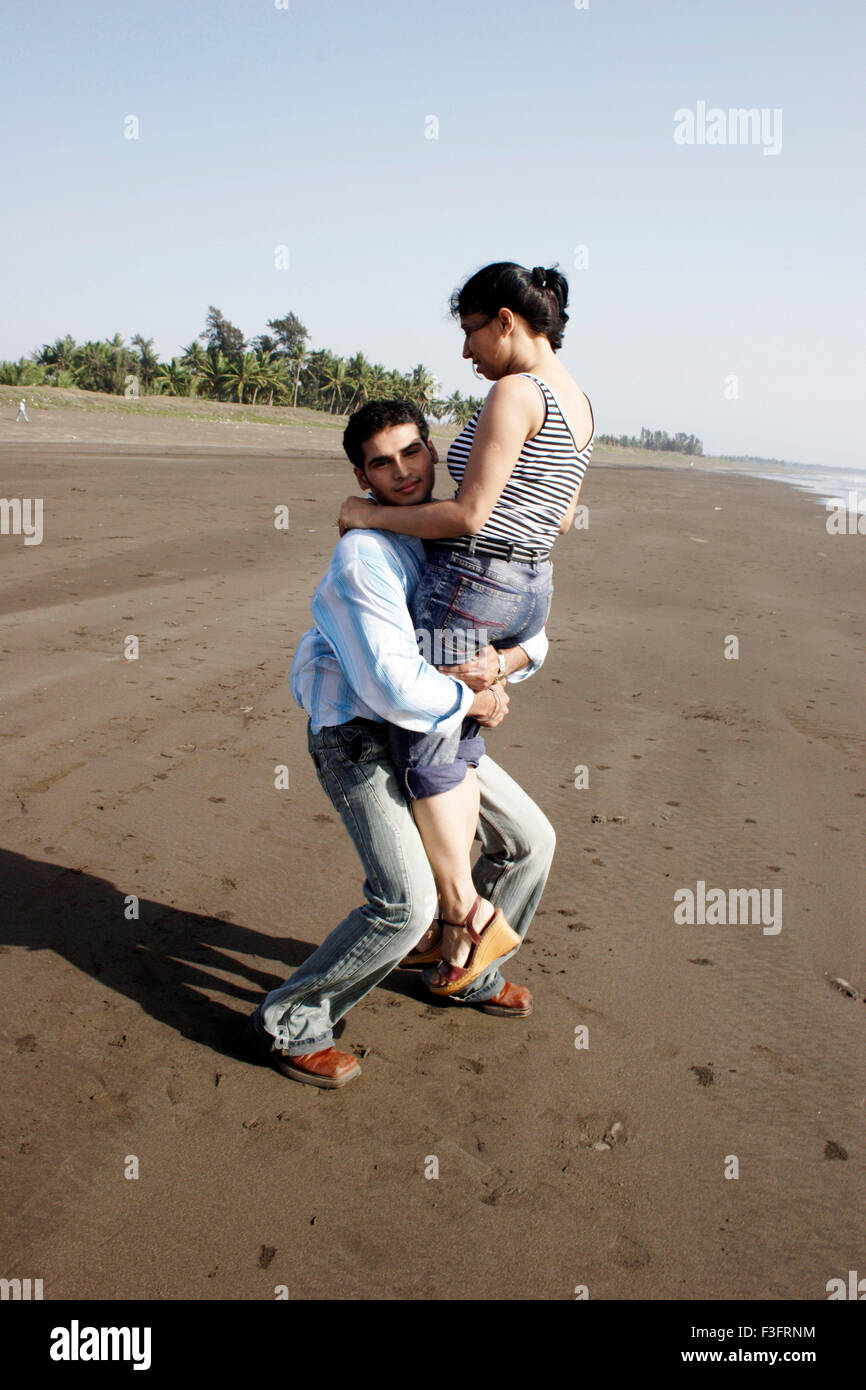 South Asian Indian man carrying woman in arm MR#724;723 Stock Photo - Alamy