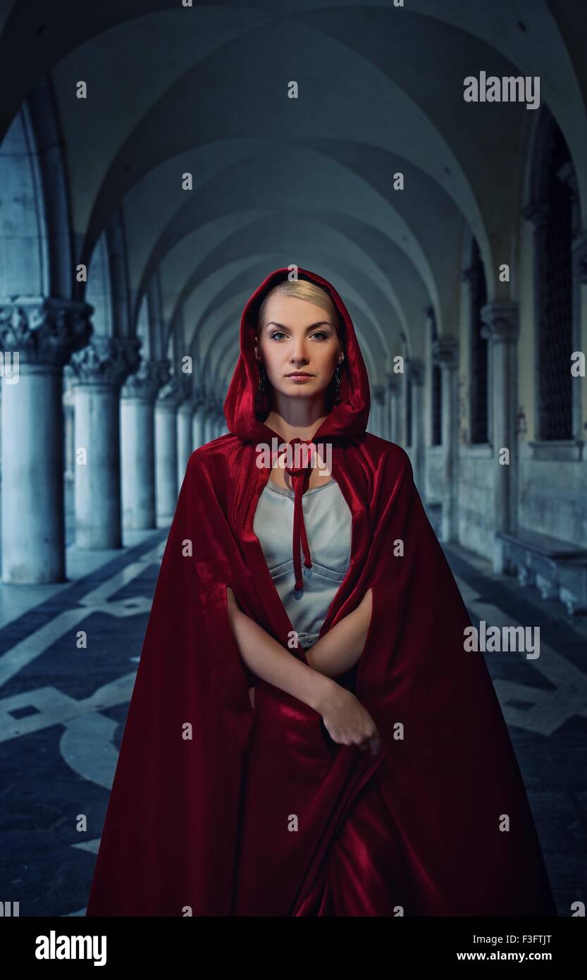 Beautiful woman in red cloak outdoor Stock Photo - Alamy