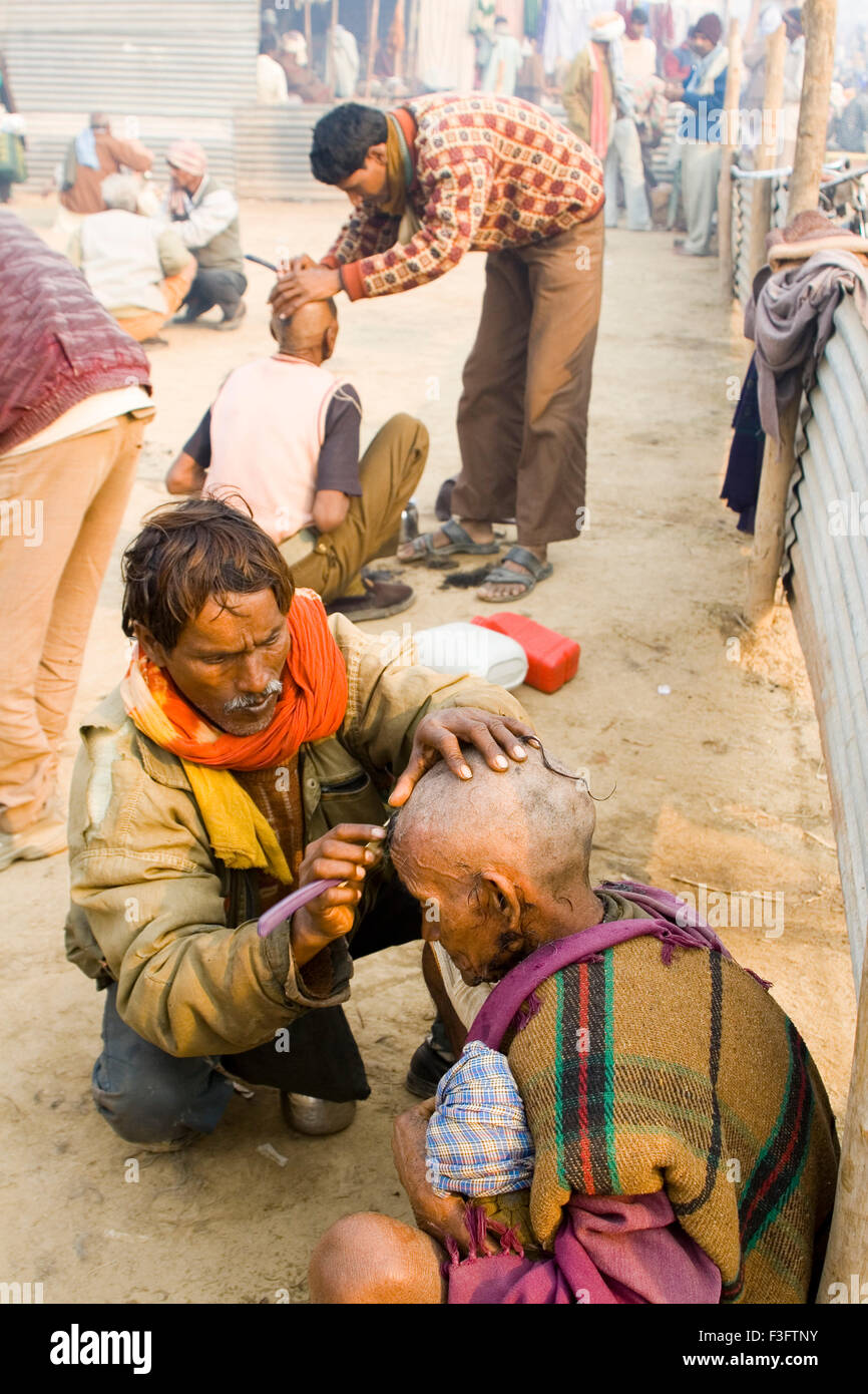 Barber cutting hair for Hindu ceremony in Kumbh mela ; Allahabad ...