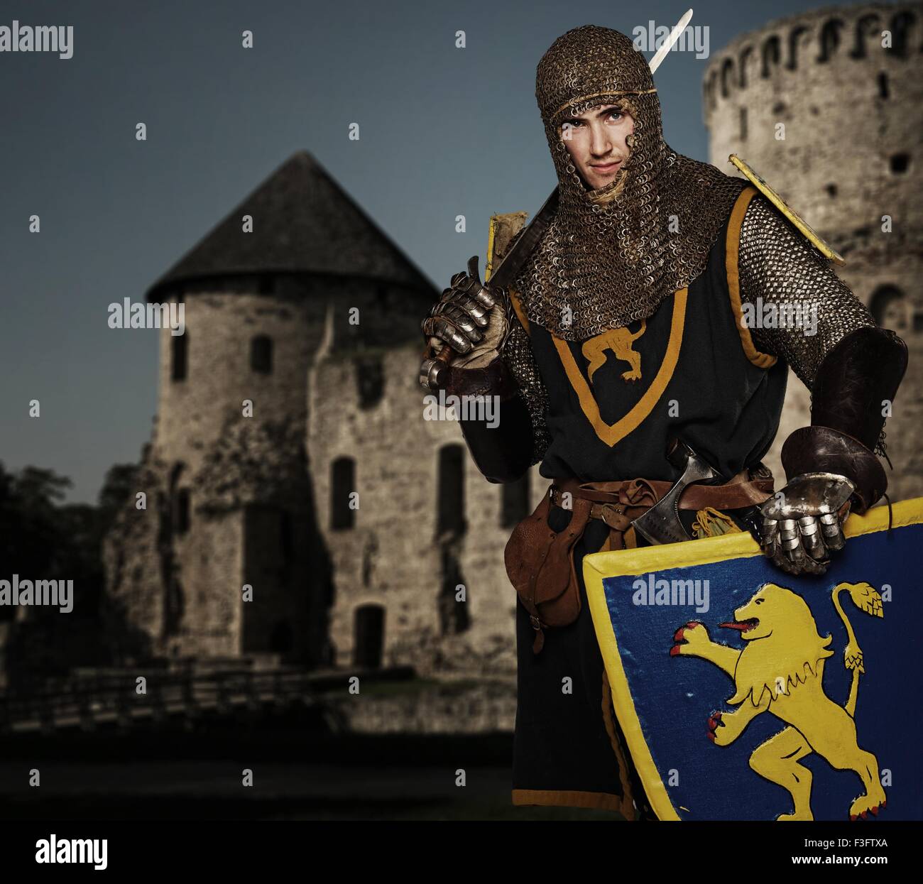 Knight against medieval castle Stock Photo - Alamy