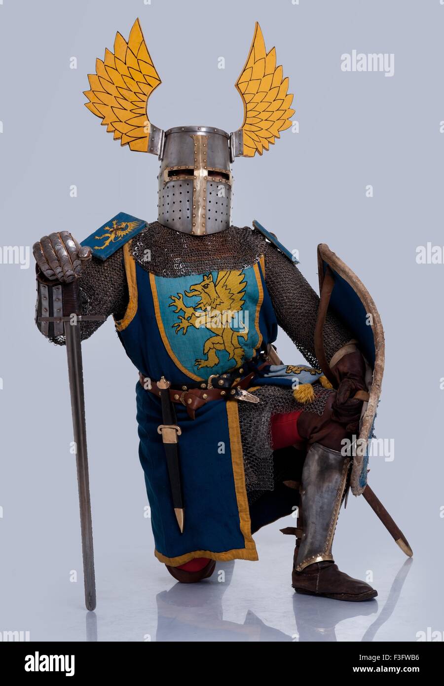 Medieval knight standing on his knee Stock Photo - Alamy