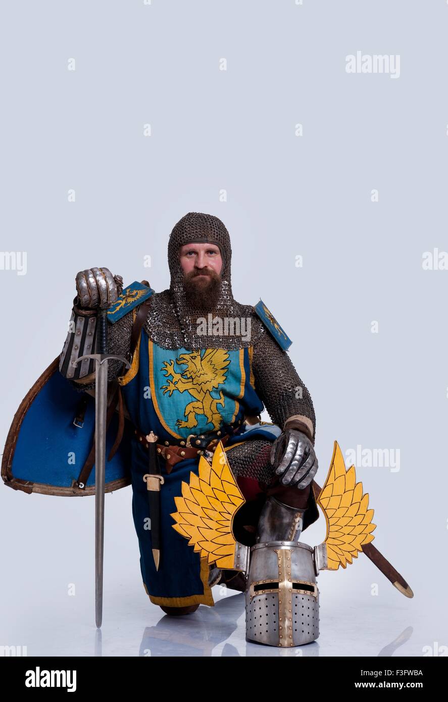 Medieval knight standing on his knee Stock Photo - Alamy