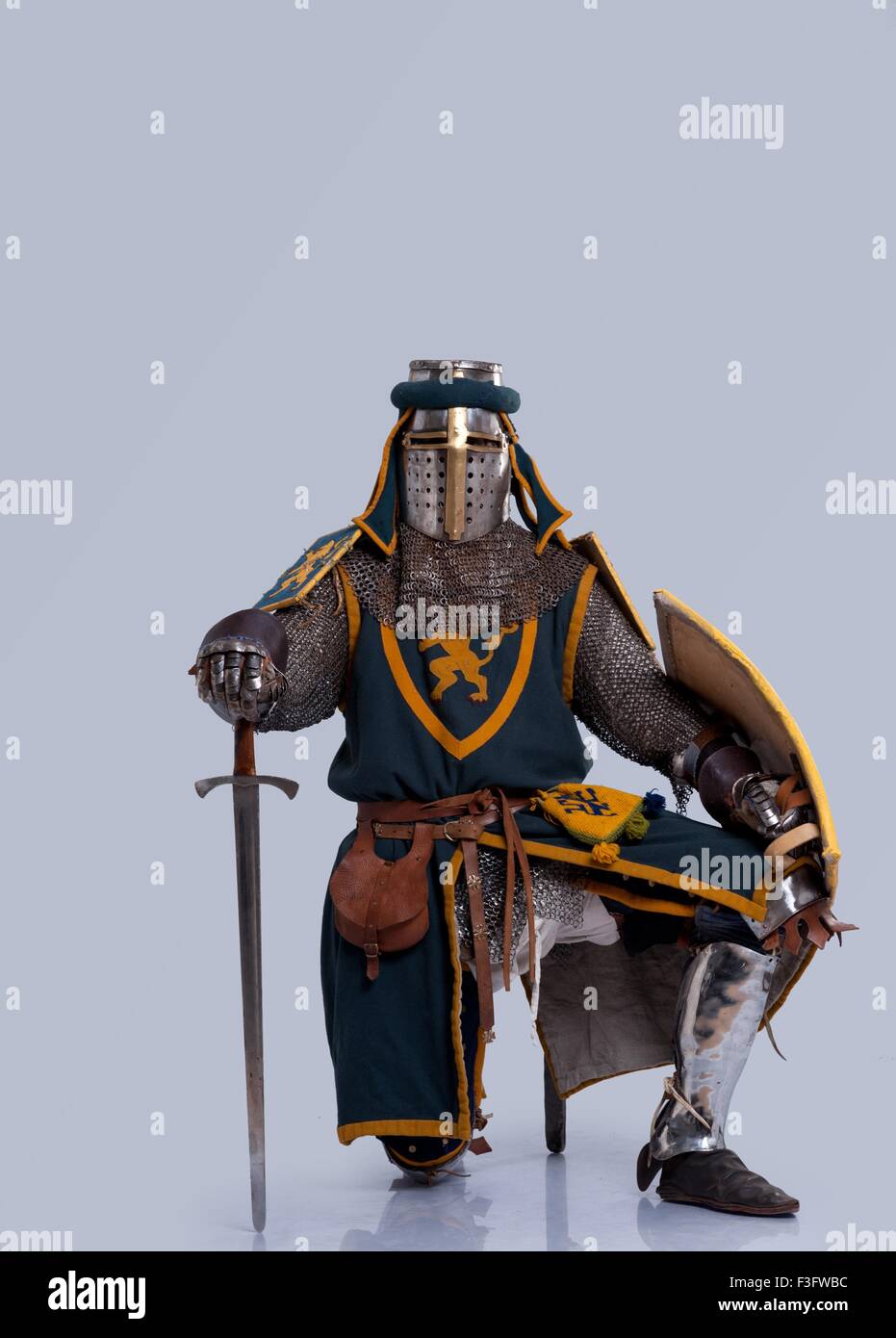 Medieval knight standing on his knee Stock Photo - Alamy