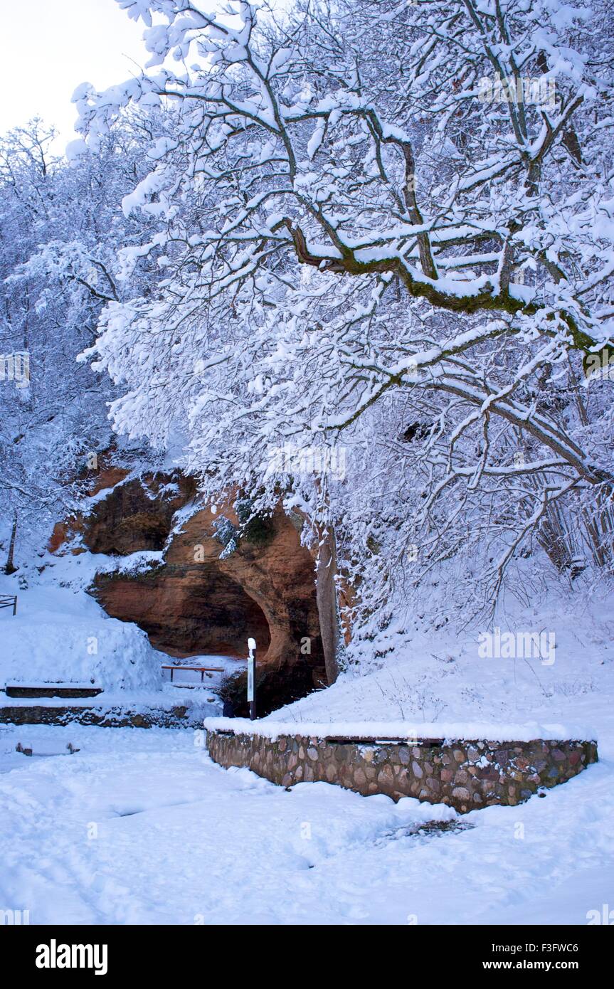 Cave in beautiful winter landscape Stock Photo - Alamy