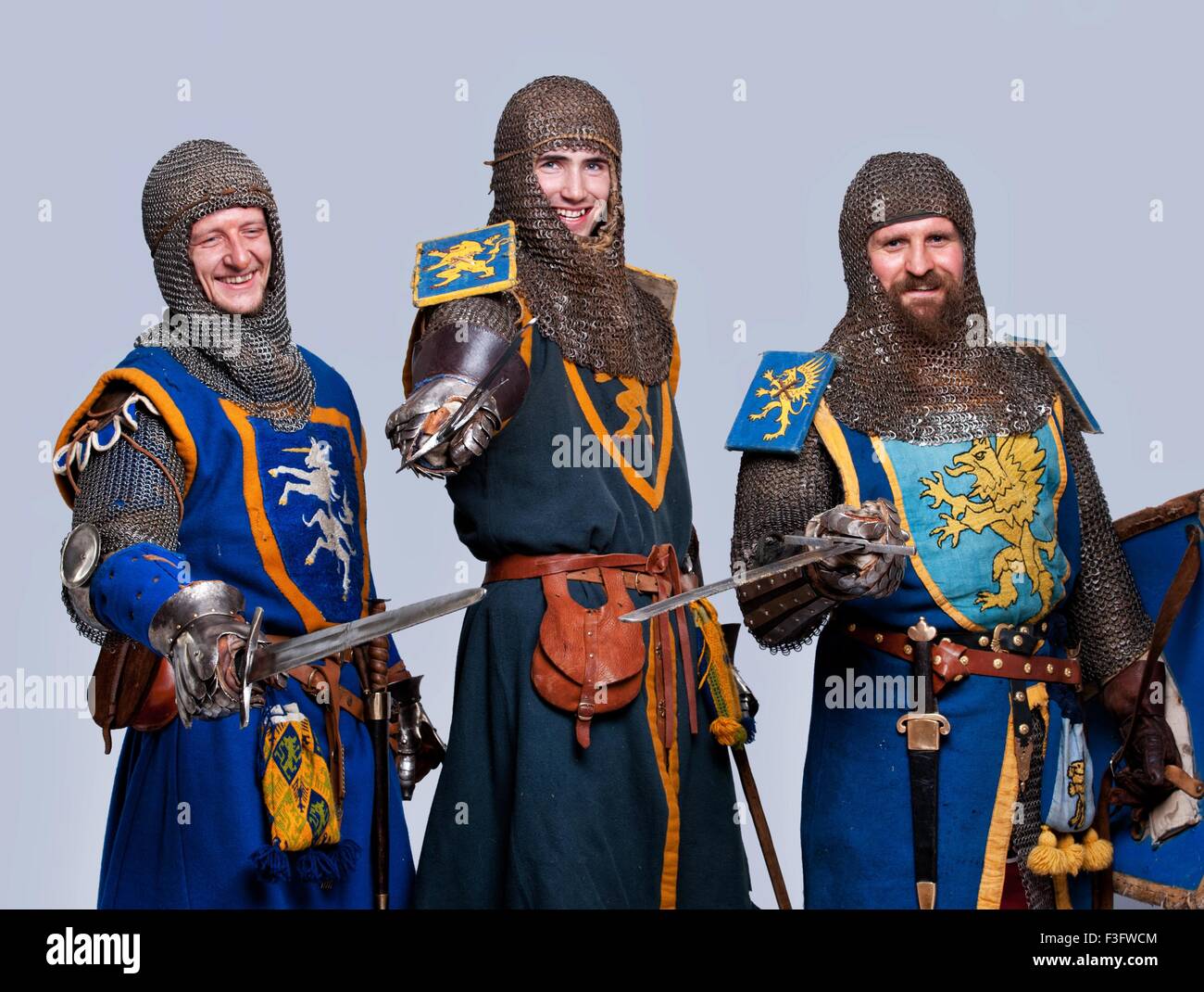 Three medieval knights isolated on grey background Stock Photo - Alamy