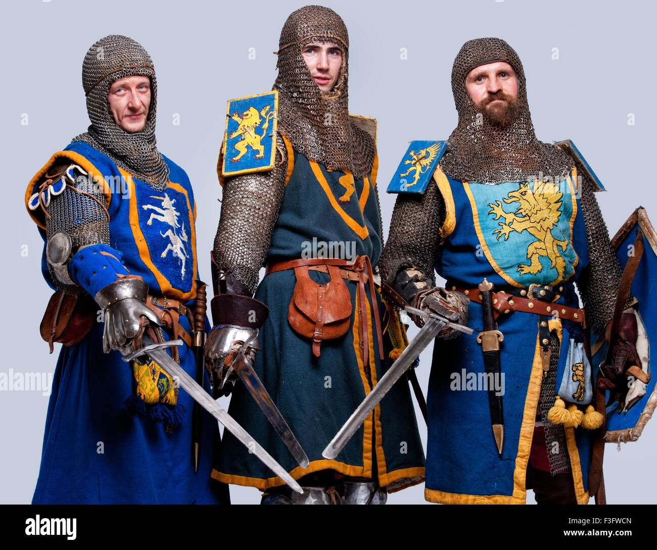 Three medieval knights isolated on grey background Stock Photo - Alamy