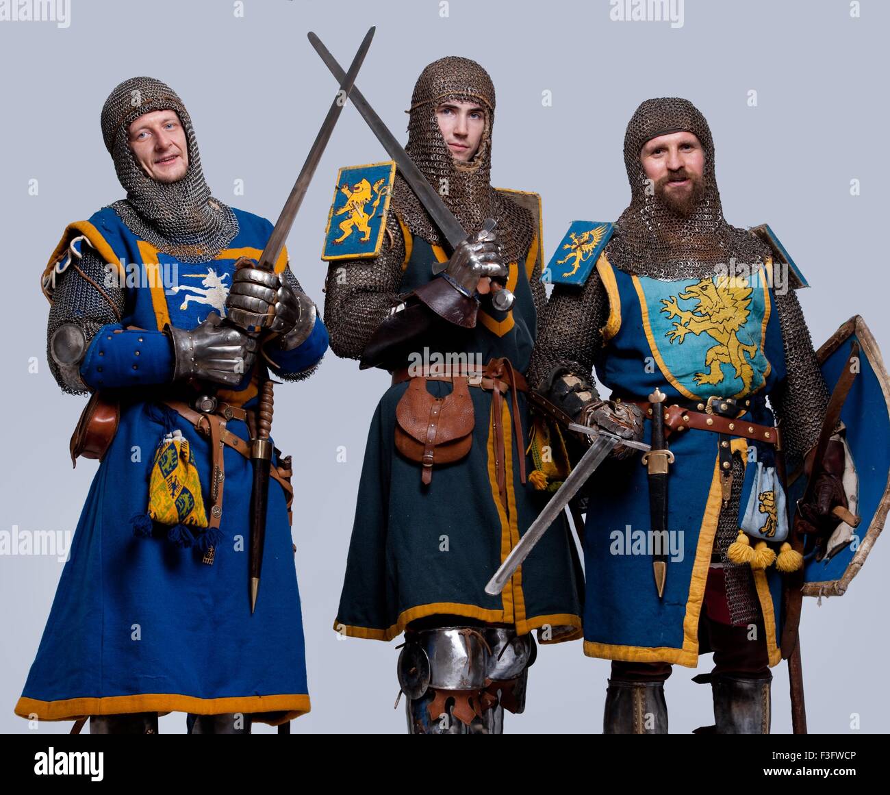 Three medieval knights isolated on grey background Stock Photo - Alamy