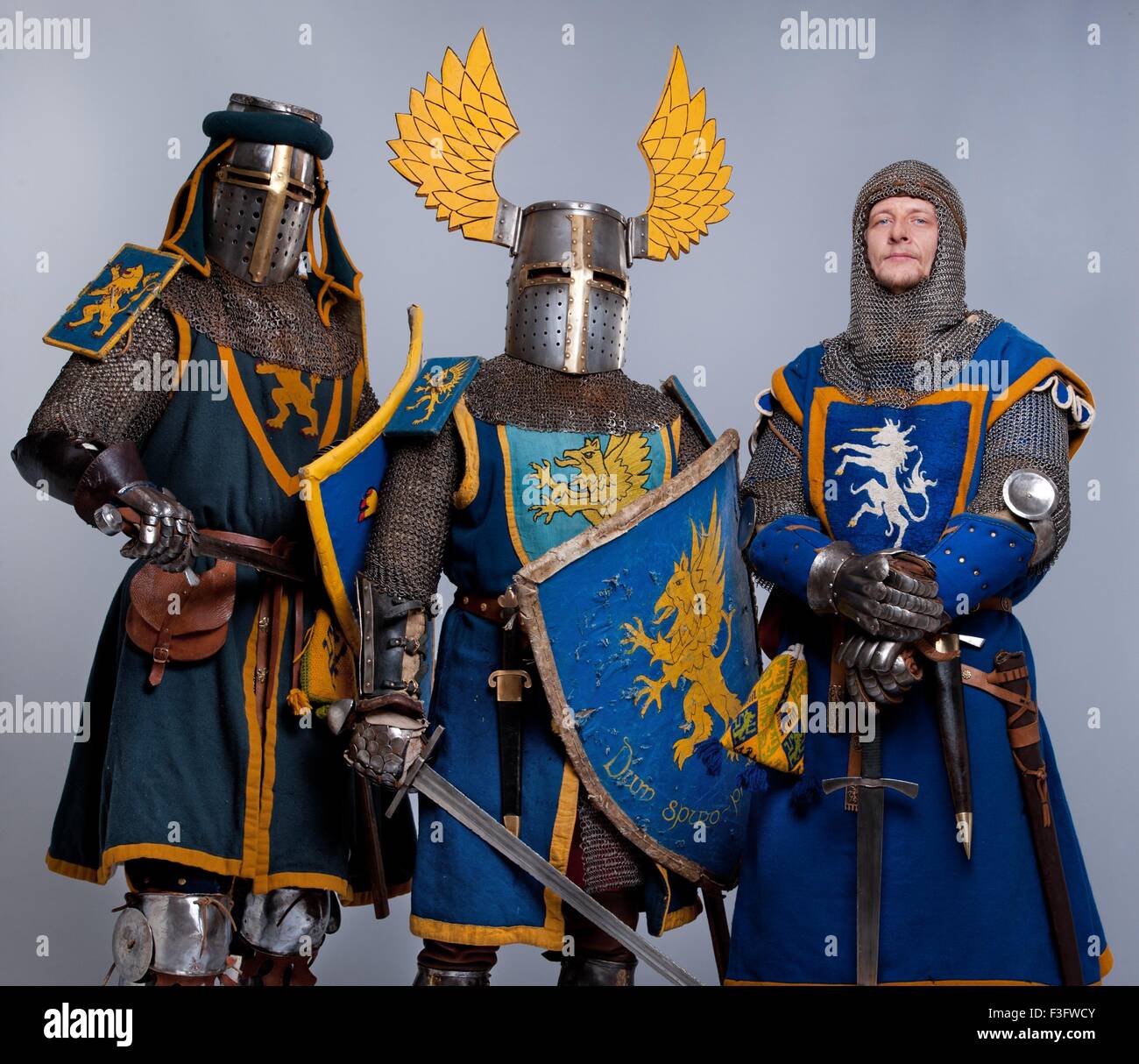 Three medieval knights isolated on grey background Stock Photo - Alamy