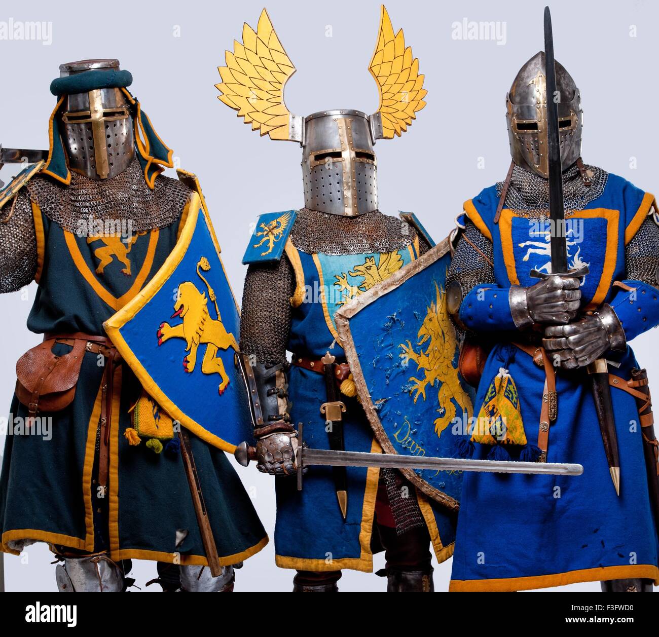 Three medieval knights isolated on grey background Stock Photo - Alamy