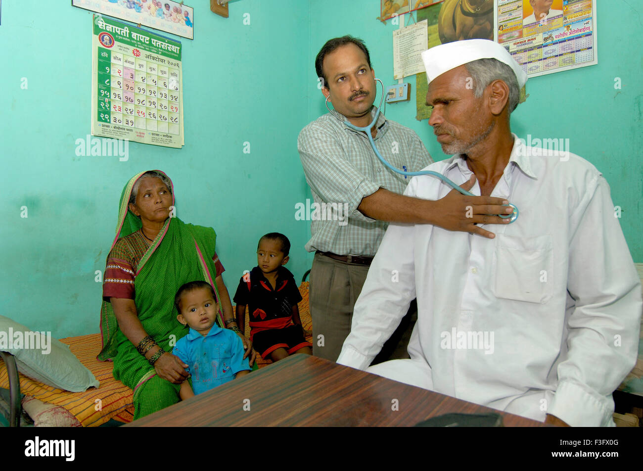Doctor examining villagers at private clinic at Ralegan Siddhi near ...