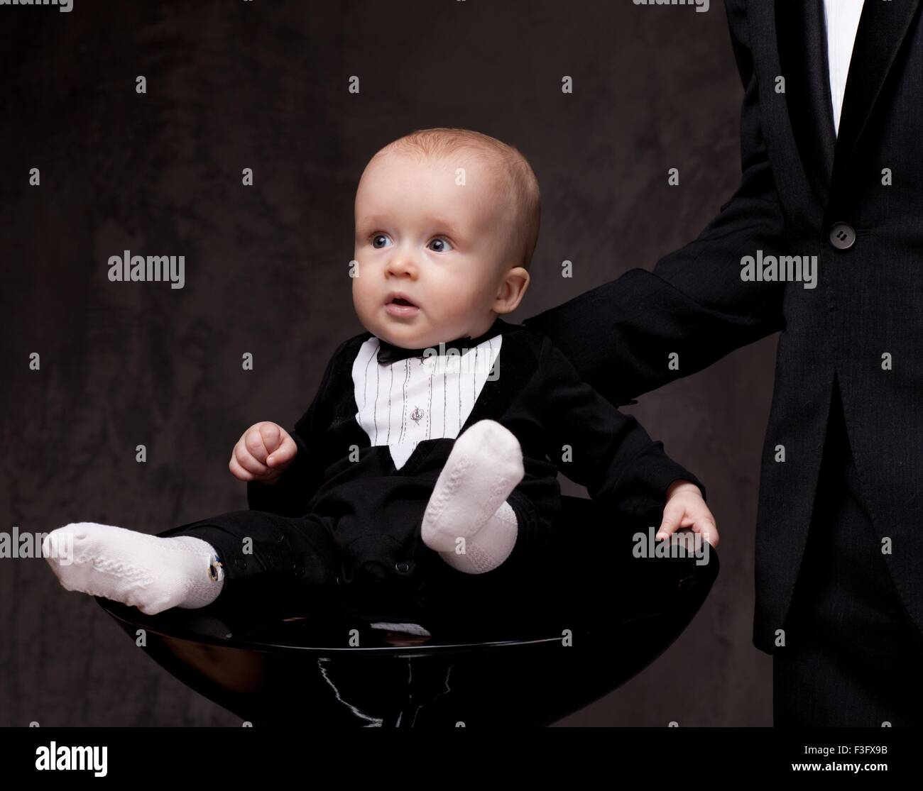 Cute baby sitting on chair Stock Photo - Alamy