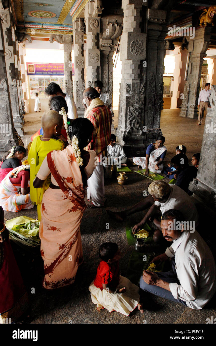 Devotees taking food in temple Urchava mandap of Meenakshi ...