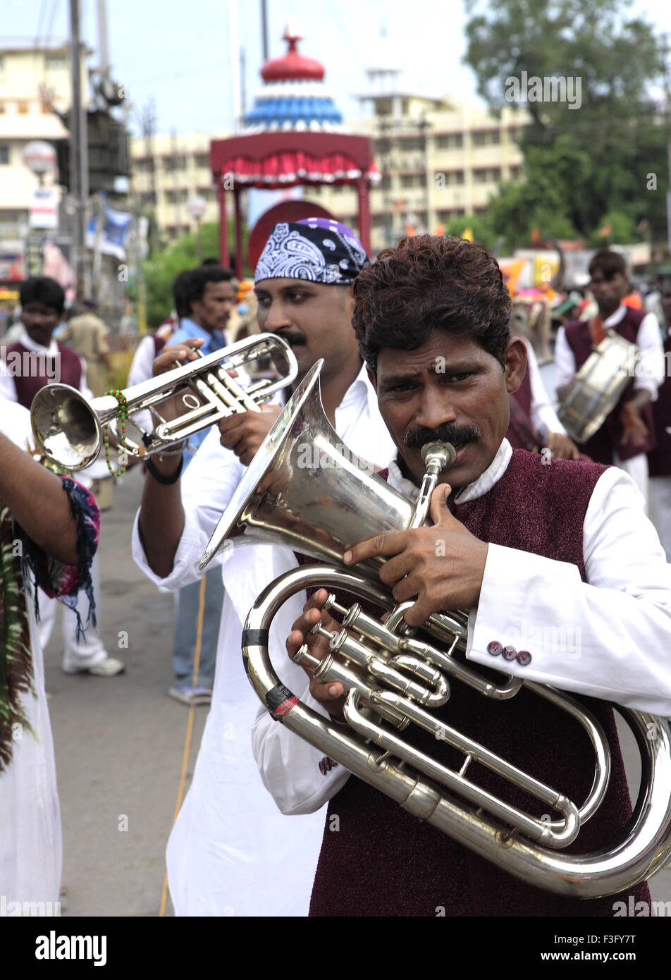 Janmashtami festival Lord Krishna birthday carnival procession band musician playing bass tuba ...