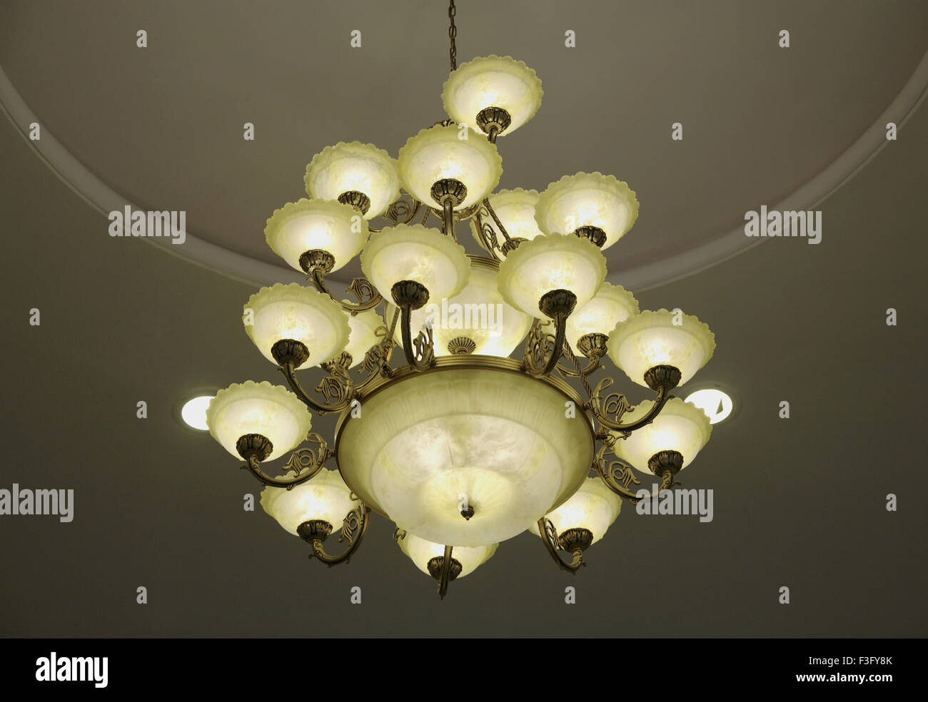 Chandelier with multiple lamps hanging from ceiling Stock Photo - Alamy