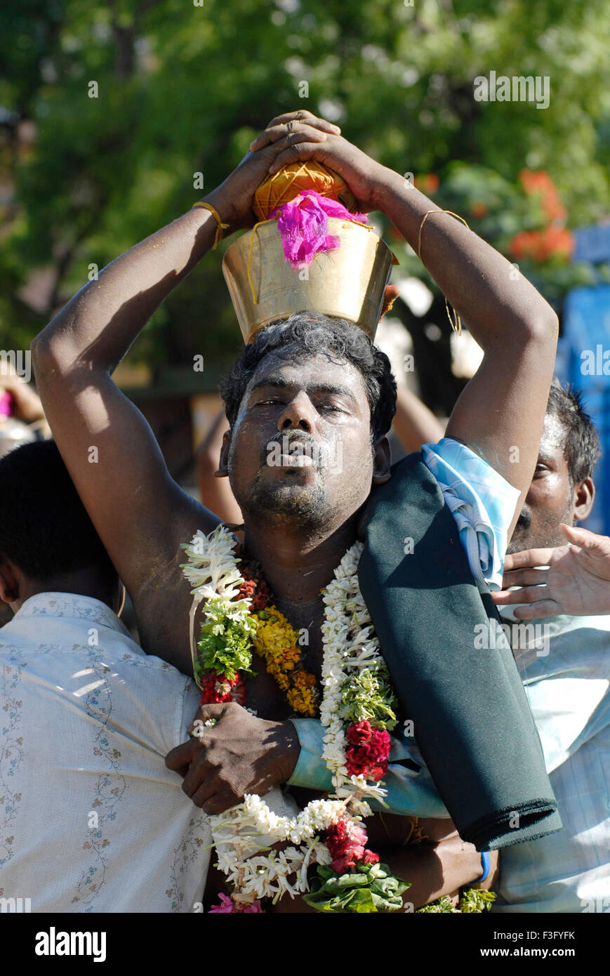 Man carrying milk pot in trance ; Tirupparankundram ; Tamil Nadu ...