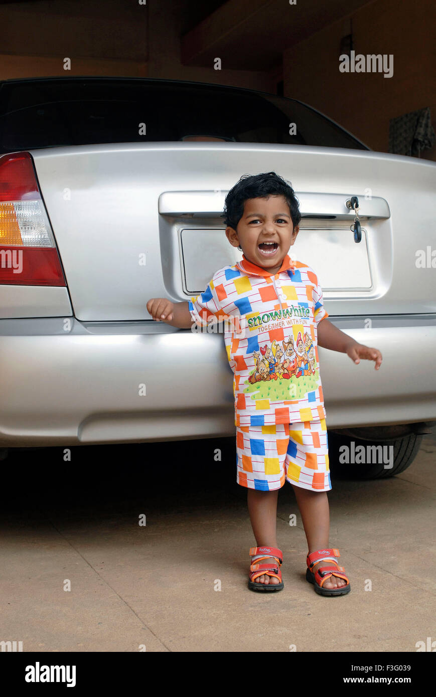 happy boy standing near new car MR#7 MR#777I Stock Photo - Alamy