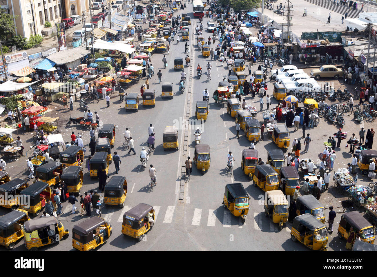 Three wheelers on busy road under Charminar ; ; Andhra Pradesh ; India ...