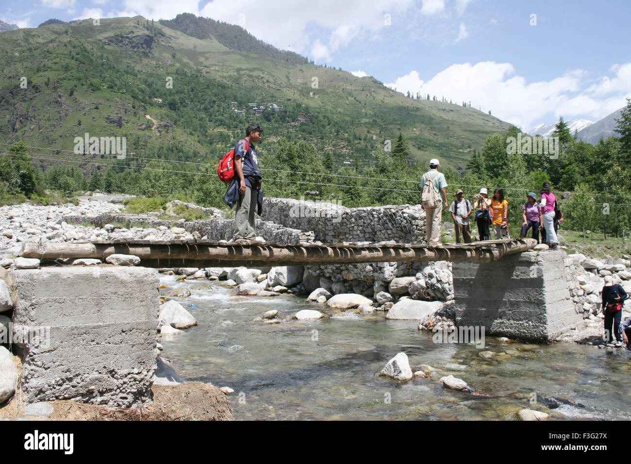 Tourists crossing wooden bridge ; Manali ; Himachal Pradesh ; India ...