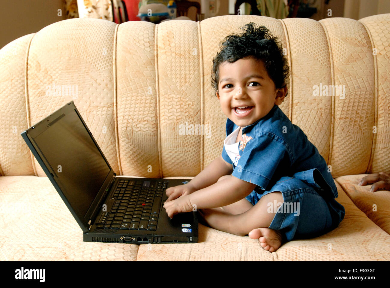 Boy operating laptop hi-res stock photography and images - Alamy
