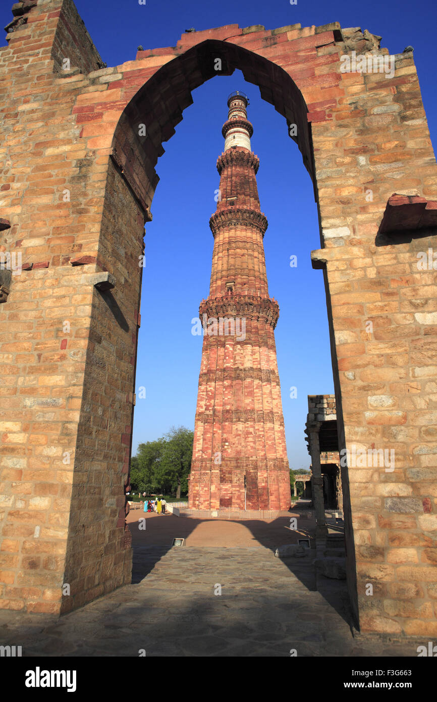 Qutb Minar through arch built in 1311 red sandstone tower ; Indo Muslim ...