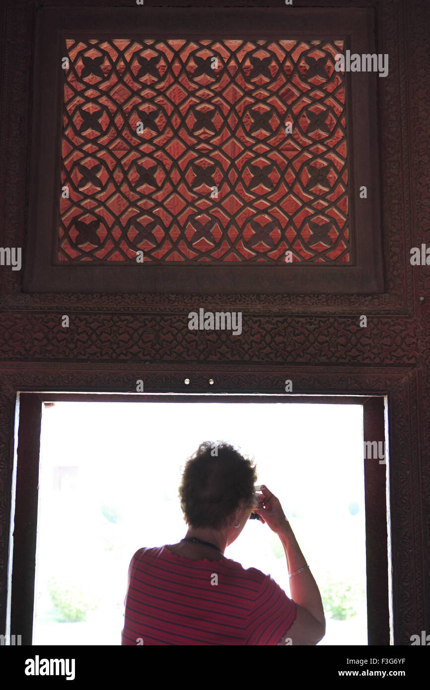 Tourist in window of Diwan e Khas in Fatehpur Sikri ; Agra ; Uttar ...