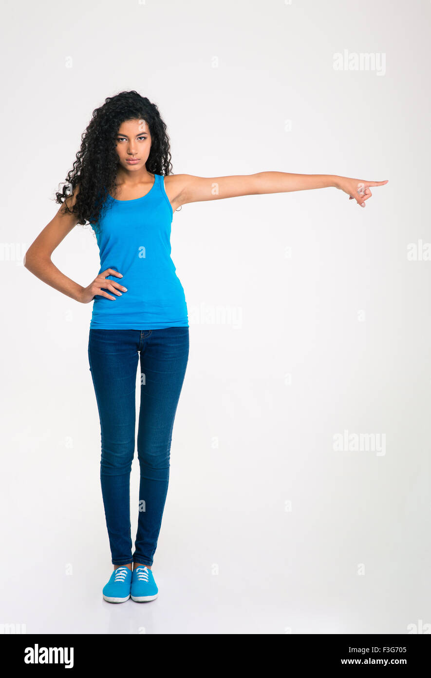 Full length portrait of a serious afro american woman pointing finger ...