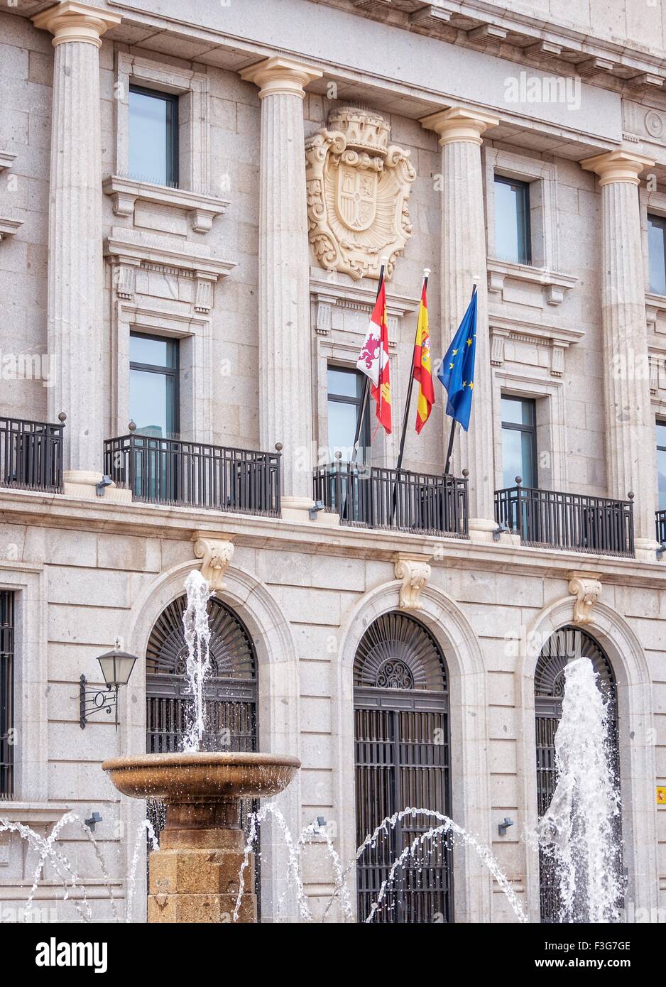 Ornate front of Spanish government building with fountain and flags ...