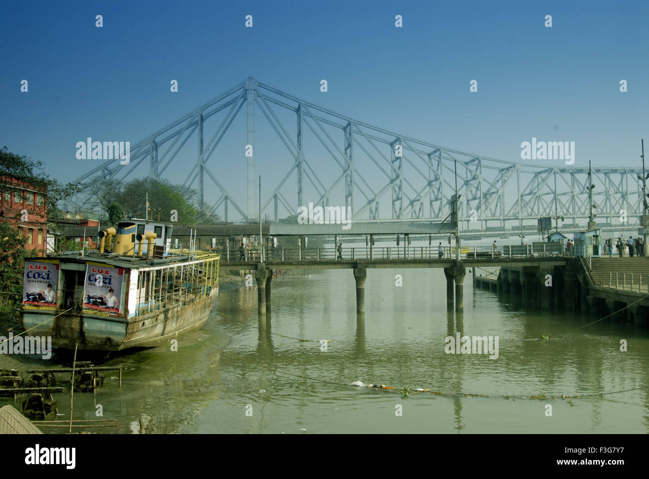 View of Howrah bridge on Hooghly river at Calcutta ; West Bengal ...