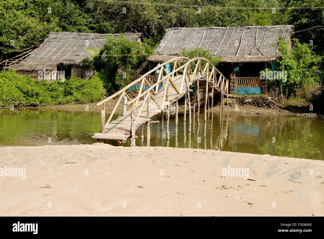 Huts with thatched roof connected by bamboo bridge at Om beach ; Kumta ...