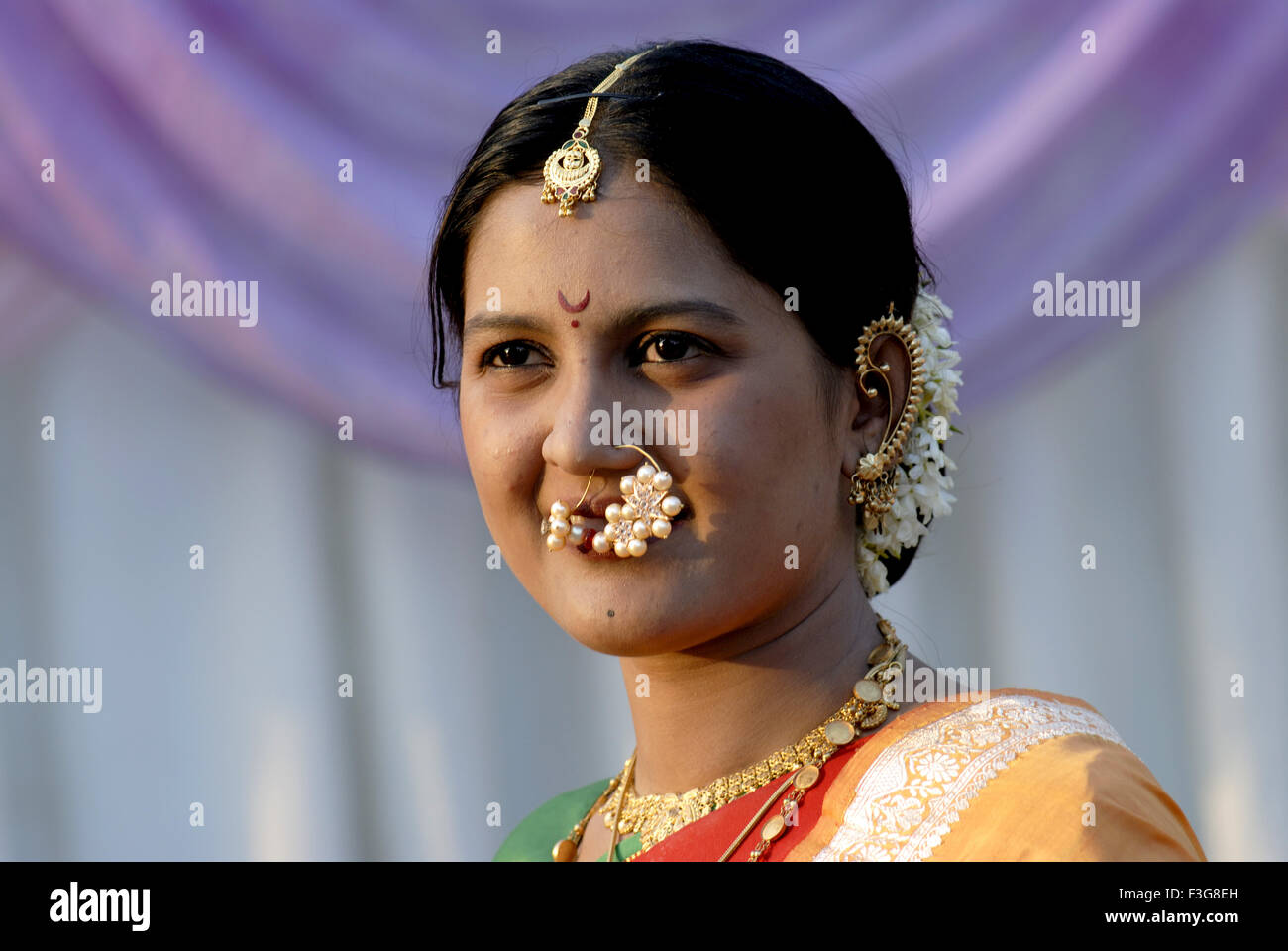 Woman wearing nine yard sari and traditional ornaments ; Bombay now ...