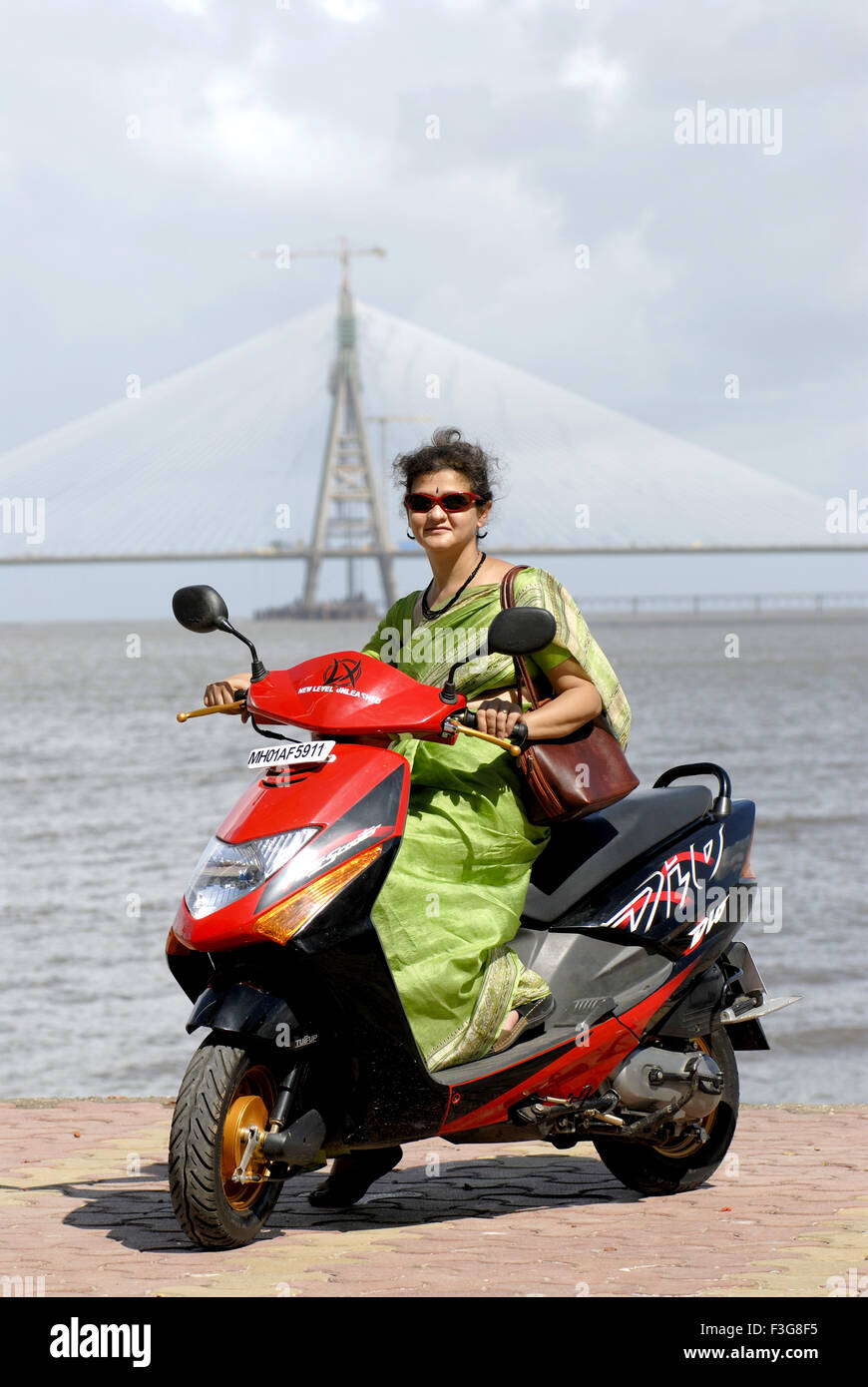 Working women driving Moto scooter ; Bombay now Mumbai ; Maharashtra ...