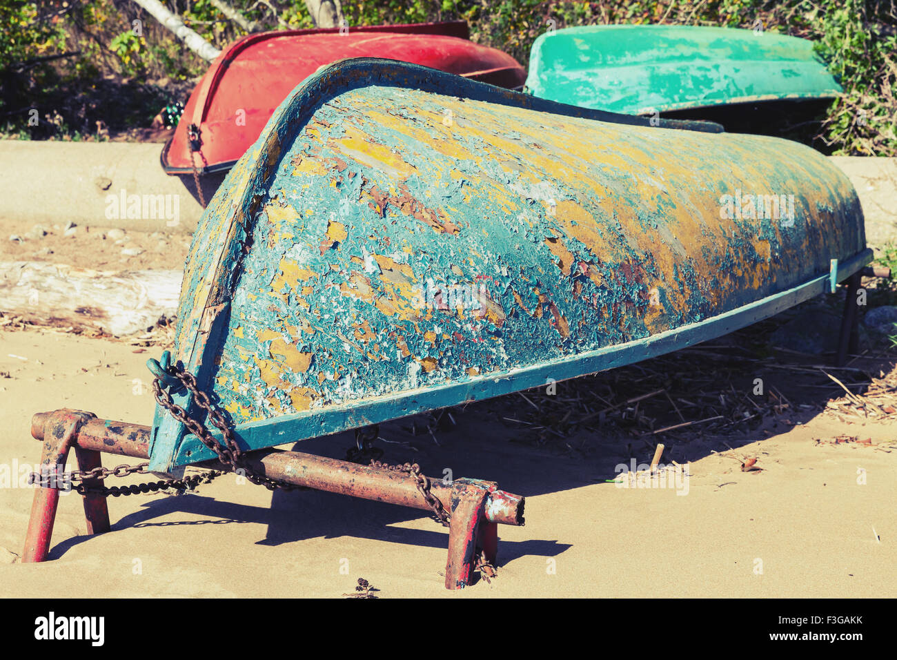 Old rowboats lay on sandy coast. Gulf of Finland, Russia. Vintage toned ...
