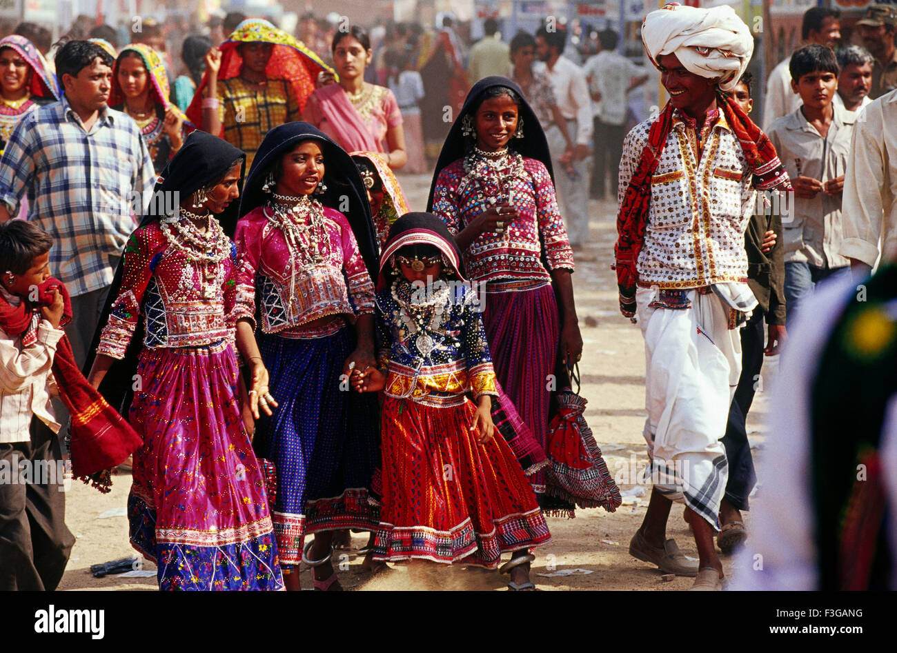 Rural women and girls walking at Ravechi fair ; Rapar ; Kutch ; Gujarat ...