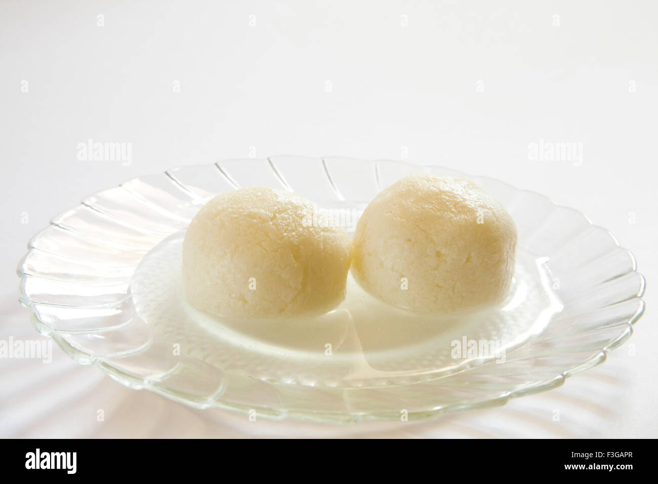Indian sweet food Bonbon Confectionery Rasgulla with sugar syrup served ...