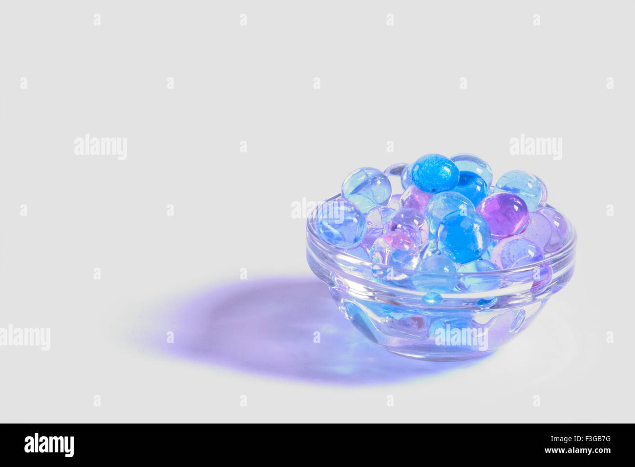Showpiece lot of Colorful gel ball in big round glass bowl on white ...