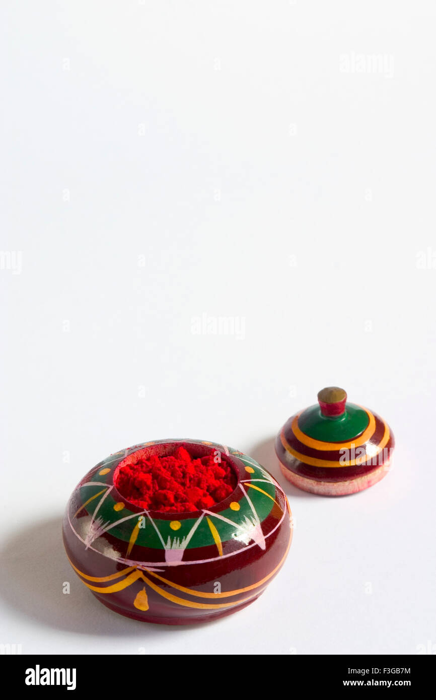 Red sindoor or kumkum or vermillion powder in wooden box on white ...